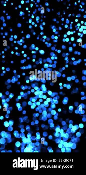 Bokeh soft blue lights rising in seamless loop vertical. Abstract ...