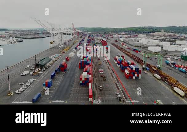 Aerial drone view of stacked shipping containers at cargo terminal ...