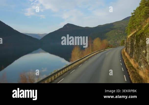 Scenic road along a fjord with mountains and forest in Norway Stock ...