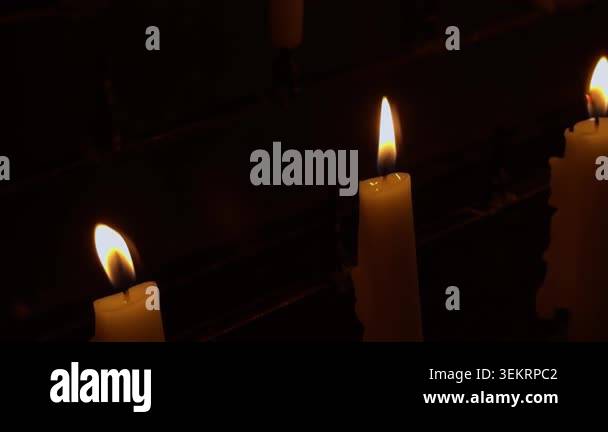 Atmospheric Close Up Shot Of Several Votive Candles Burning On A Stand ...