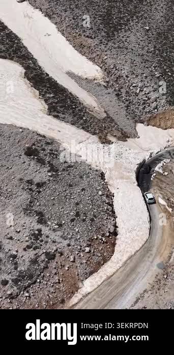 Mountain road cars. Snow-covered mountain road, high snowdrifts on the ...