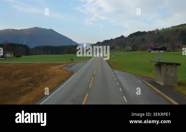 Rural road passing a red barn and mountain valley in Norway Stock Video ...