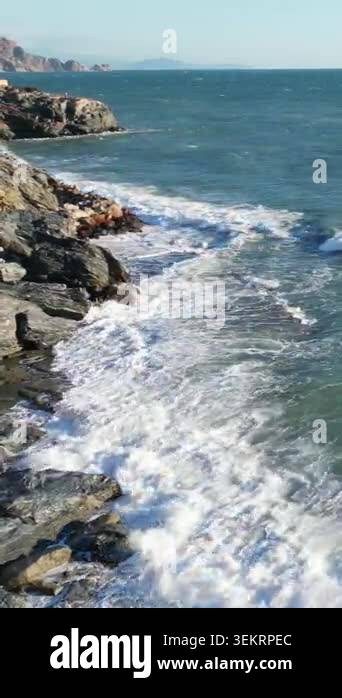 Cliffside turquoise sea. Ocean rocky cliff. Waves crashing rocks. High ...