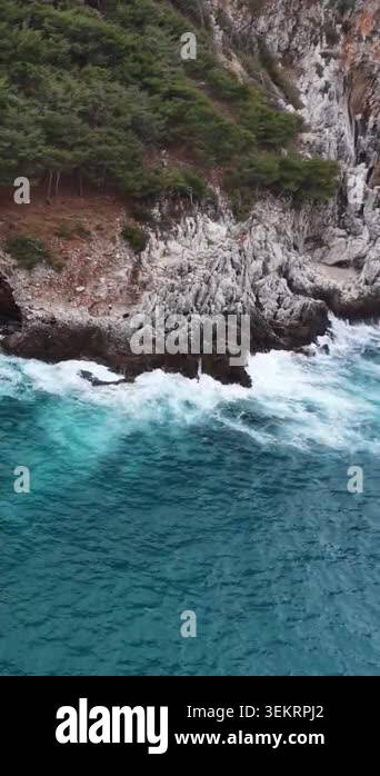 Cliffside turquoise sea. Ocean rocky cliff. Waves crashing rocks. High ...