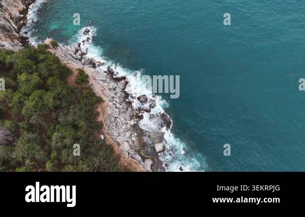 Cliffside turquoise sea. Ocean rocky cliff. Waves crashing rocks. High ...