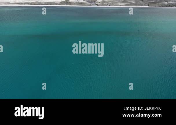 view from a drone of a lake in the mountains, turquoise water. High ...