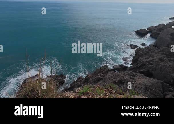 Cliffside turquoise sea. Ocean rocky cliff. Waves crashing rocks. High ...