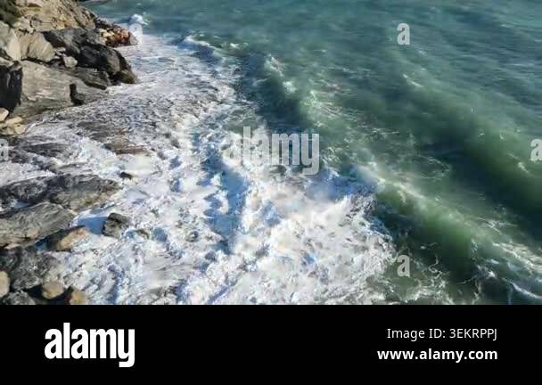 Cliffside turquoise sea. Ocean rocky cliff. Waves crashing rocks. High ...