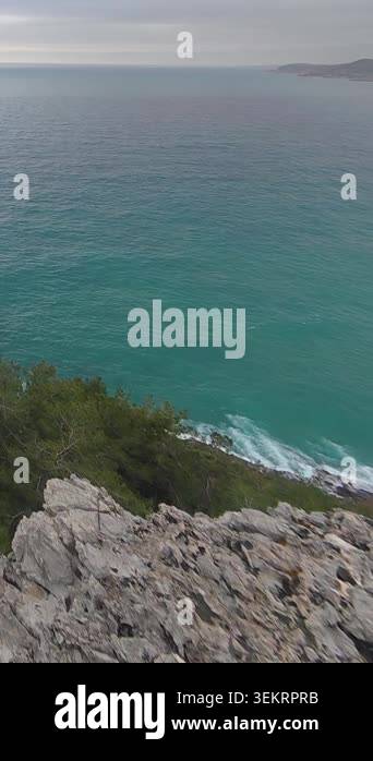Cliffside turquoise sea. Ocean rocky cliff. Waves crashing rocks. High ...