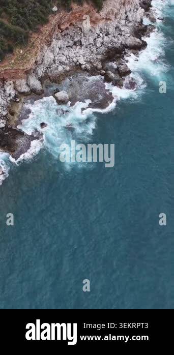 Cliffside turquoise sea. Ocean rocky cliff. Waves crashing rocks. High ...