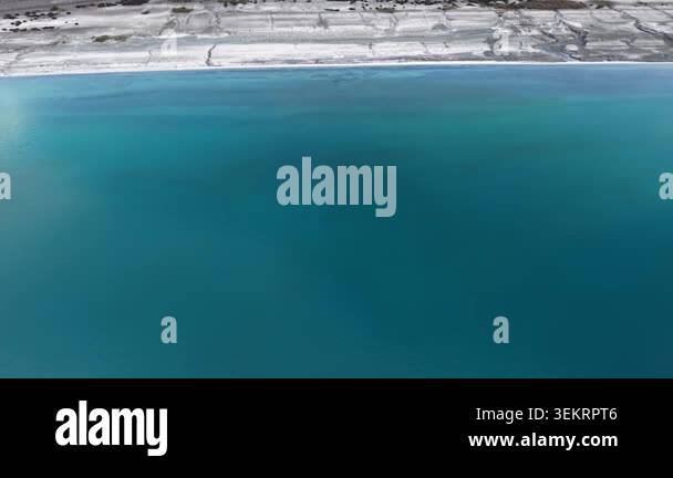 view from a drone of a lake in the mountains, turquoise water. High ...
