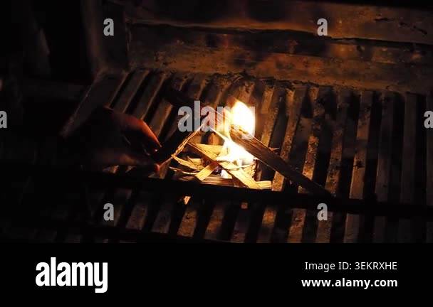 A close-up macro video of intense orange and red glowing embers on a ...