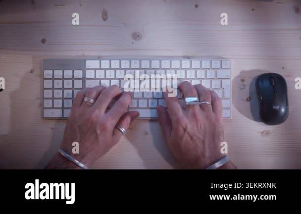 POV of hands typing on a modern computer keyboard for an online ...