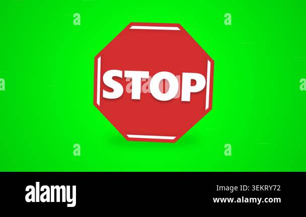 A red stop sign with white letters on a vibrant green screen background ...