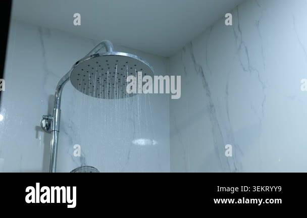Close up of shower water flowing in modern bathroom, relaxation and ...