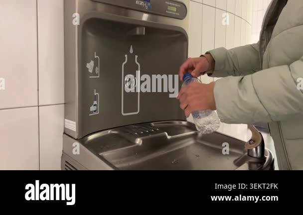 Canada. Ontario - 10.17.23 A person places a water bottle under a ...