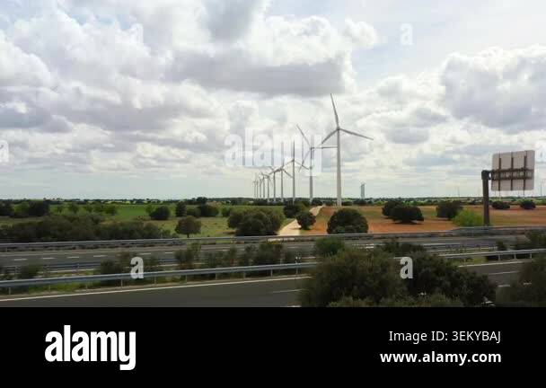 Majestic wind turbines spin gracefully against a backdrop of open ...