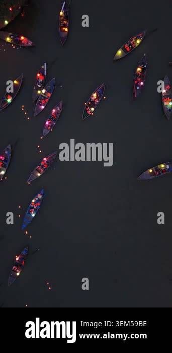 Top down aerial view of many traditional boats with colorful lights and ...