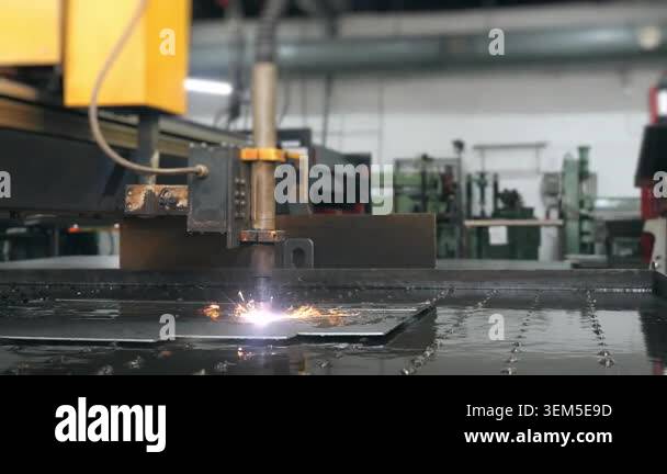 Industrial CNC plasma cutting machine processing metal sheet with ...