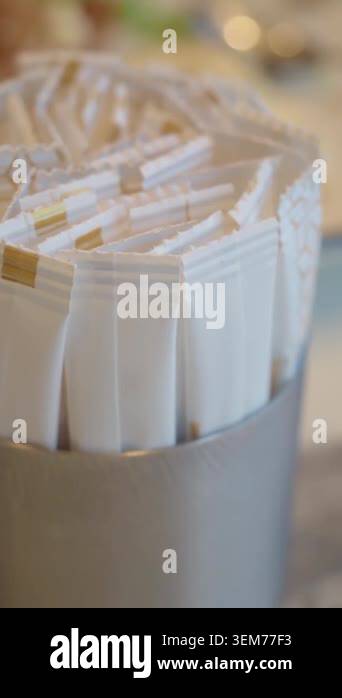 Sugar packets are stacked in a round container in a cafe Stock Video ...