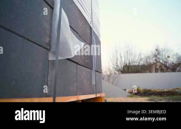 Stacked grey concrete blocks on pallet at construction site close-up ...