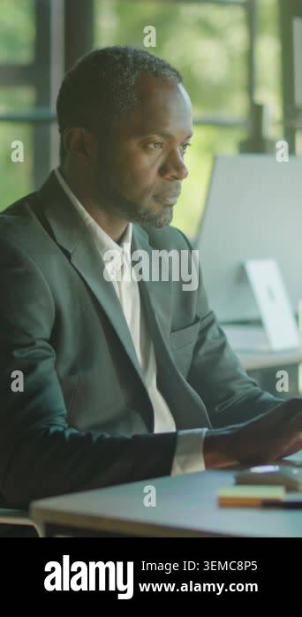 black executive serious at desktop screen, scanning financial report ...