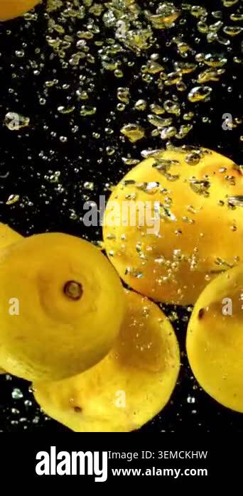 Lemons under water with air bubbles. Filmed on a high-speed camera at ...