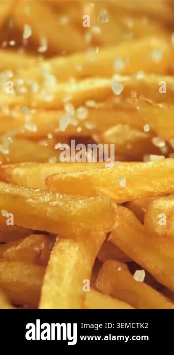 Salt falls on the french fries. Filmed on a high-speed camera at 1000 ...