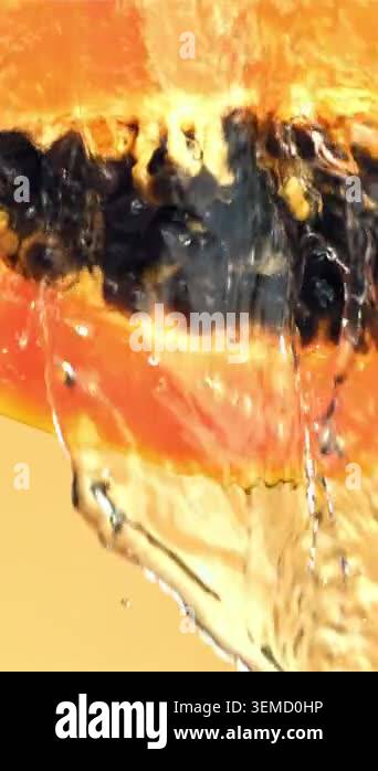 Fresh tropical papaya with drops and splashes of water. Filmed on a ...