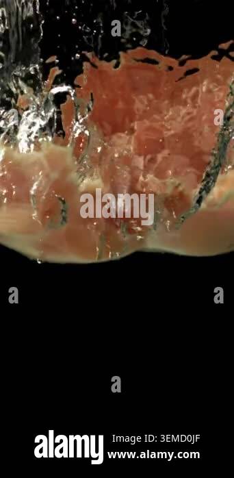 Chicken fillet falls under water. Filmed on a high-speed camera at 1000 ...