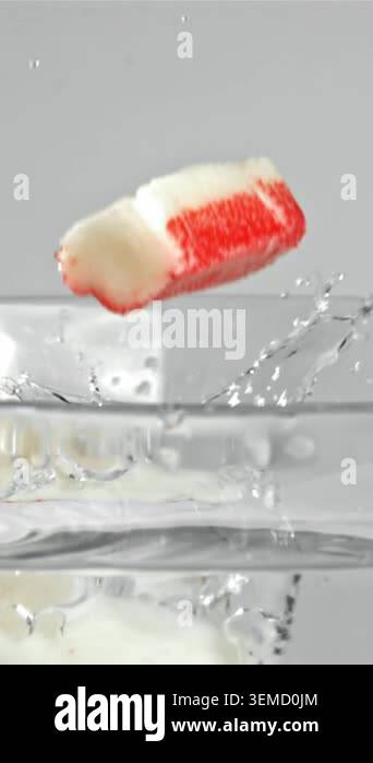 Crab sticks fall into the water. Filmed on a high-speed camera at 1000 ...