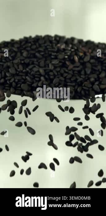 Falling sesame seeds from a spoon. Filmed is slow motion 1000 fps. High ...