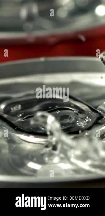 Drops of water fall on a can of cola. Filmed is slow motion 1000 fps ...