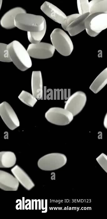 White oval tablets falling on black field, minimalist pharmaceutical ...