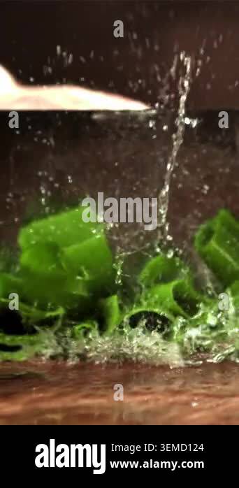 A cook chops green onions. Filmed on a high-speed camera at 1000 fps ...