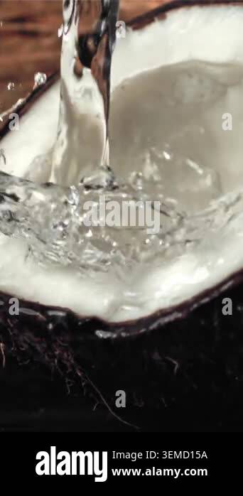 Coconut with splashes of water. Filmed on a high-speed camera at 1000 ...