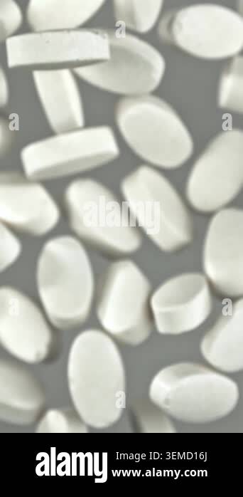 White tablets drifting through neutral space, monochrome palette Filmed ...