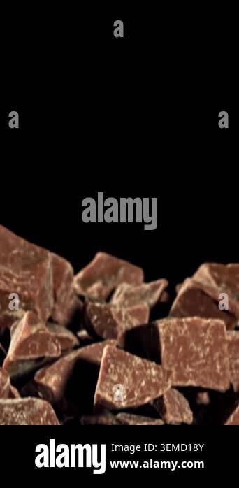 Super slow motion pieces of dark milk chocolate. Filmed on a high-speed ...