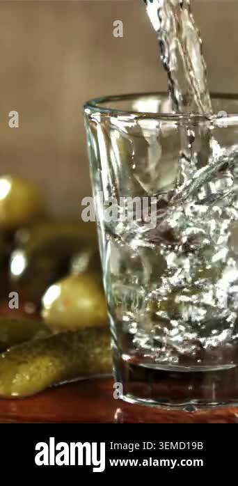 Vodka is poured into a glass. Filmed on a high-speed camera at 1000 fps ...