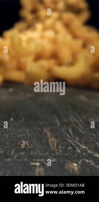 Dry pasta falls on the table. Filmed on a high-speed camera at 1000 fps ...