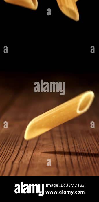 Super slow motion dry penne pasta . Filmed on a high-speed camera at ...