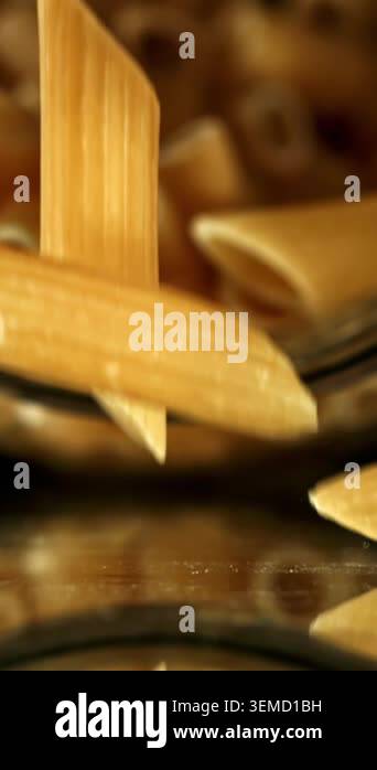 Super slow motion dry penne pasta . Filmed on a high-speed camera at ...