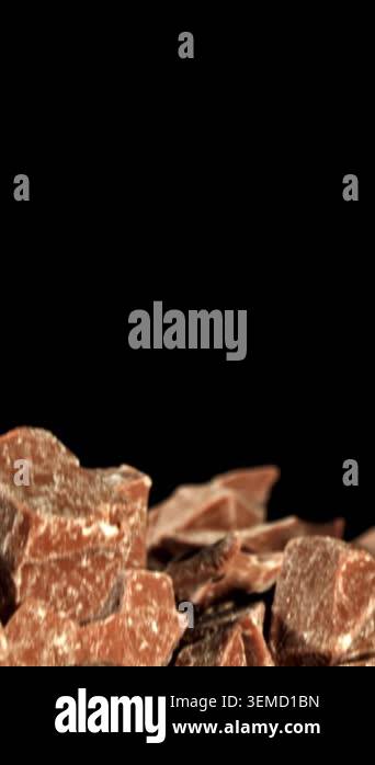 Super slow motion pieces of dark milk chocolate. Filmed on a high-speed ...