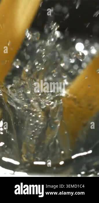 Penne pasta falls into boiling water. Filmed on a high-speed camera at ...