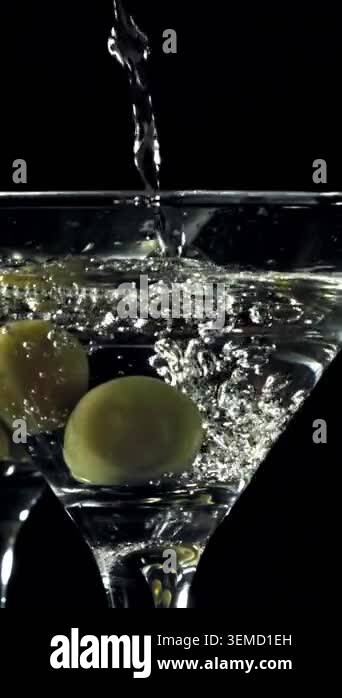 Martini is poured into a glass. Filmed on a high-speed camera at 1000 ...