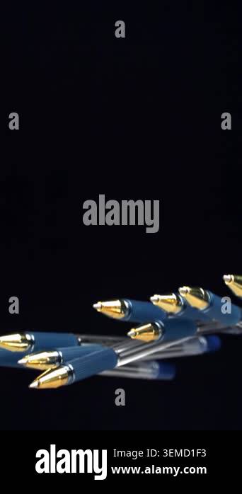 School pens fly up and down. Filmed on a high-speed camera at 1000 fps ...