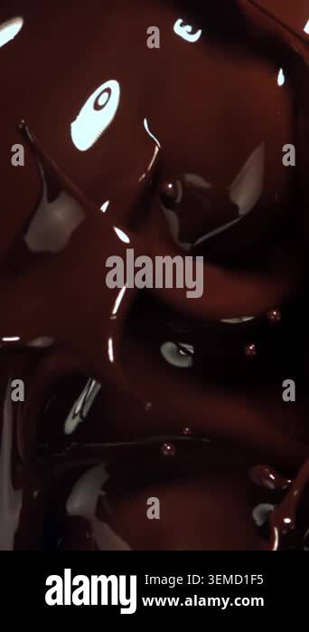 Waves and splashes of chocolate. Filmed on a high-speed camera at 1000 ...