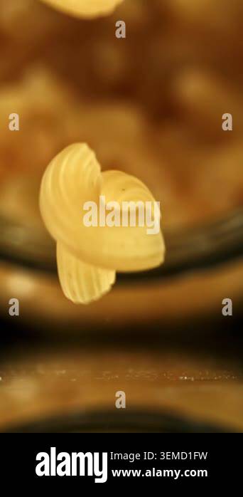 Super slow motion dry macaroni pasta . Filmed on a high-speed camera at ...