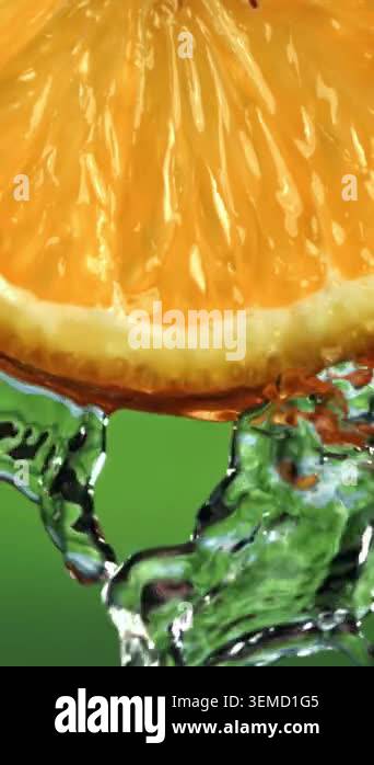 Water flows down from a round slice of orange. Filmed on a high-speed ...