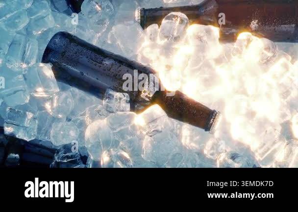 Beer Bottles On Ice In Sun Glow Stock Video Footage - Alamy